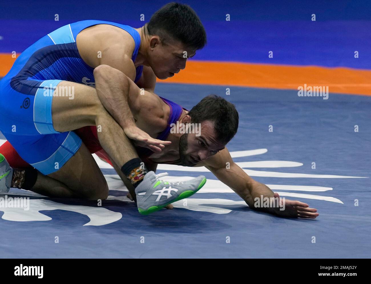 Japan's Kenichiro Fumita, top, and Azerbaijan's Murad Mammadov compete during their Greek-Roman ...