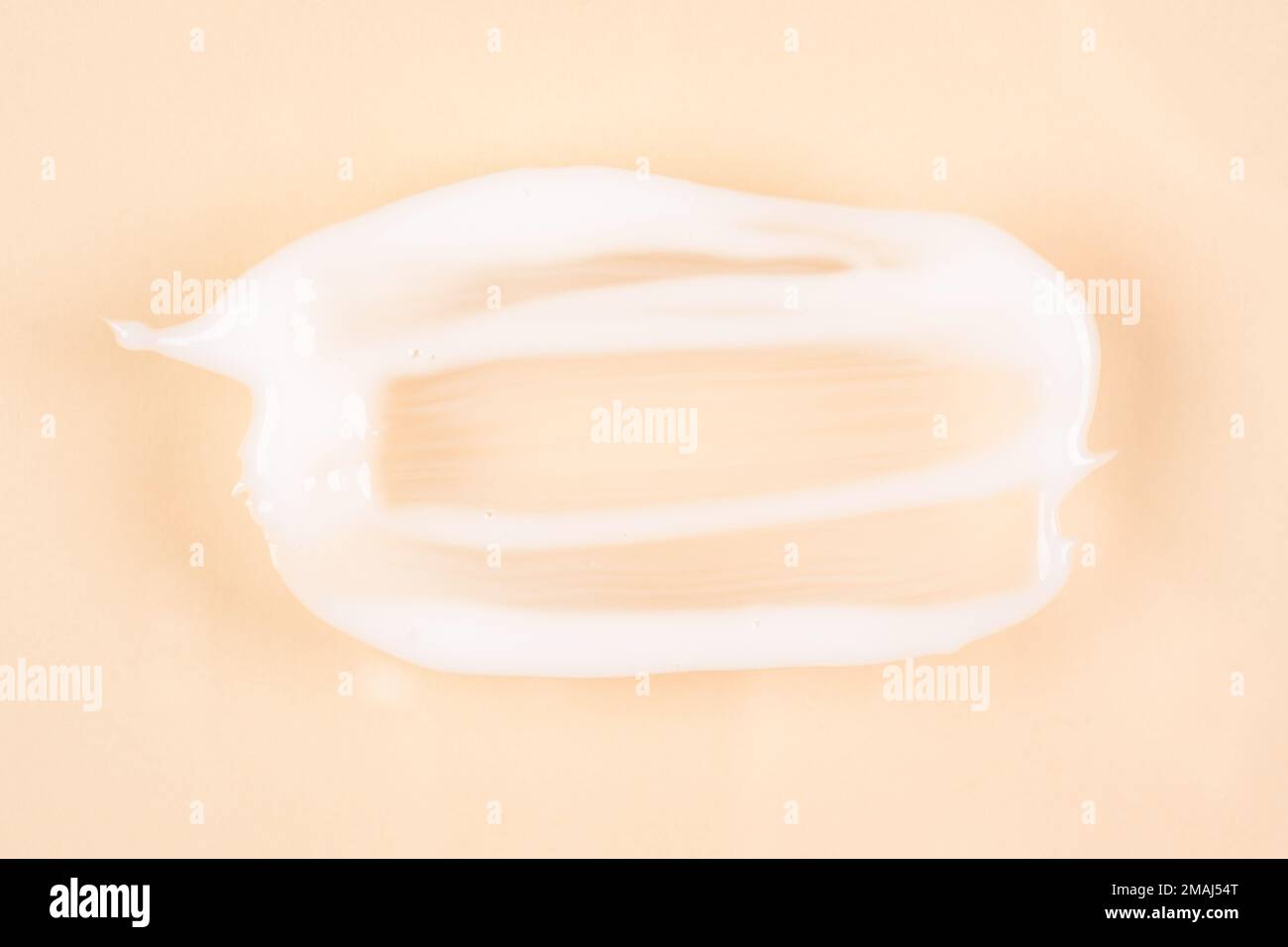 White silky cosmetic cream texture. Cream or body lotion smear over ...