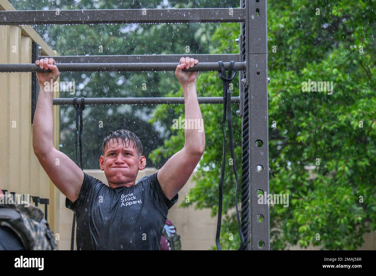 A fitness enthusiast performs pull-ups during a Murph challenge at ...