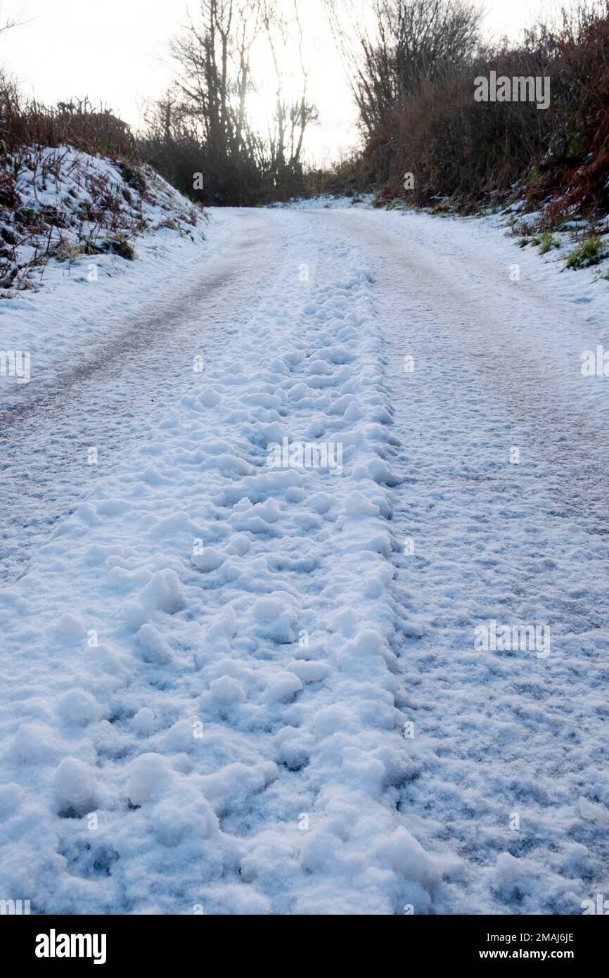 Ice and frozen snow on rural road country lane in winter January 2023 ...