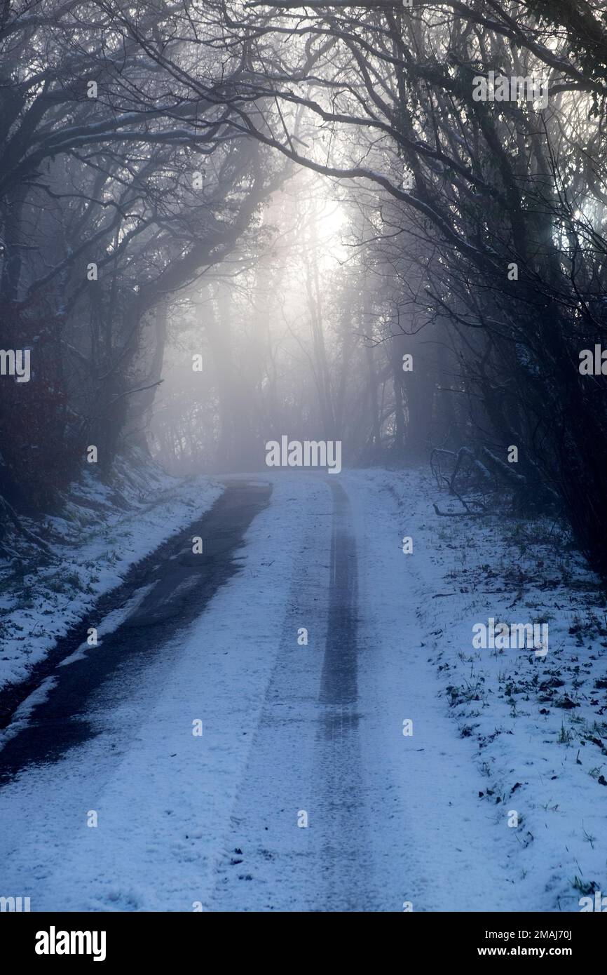Ice freezing fog and frozen snow on rural road country lane in winter ...