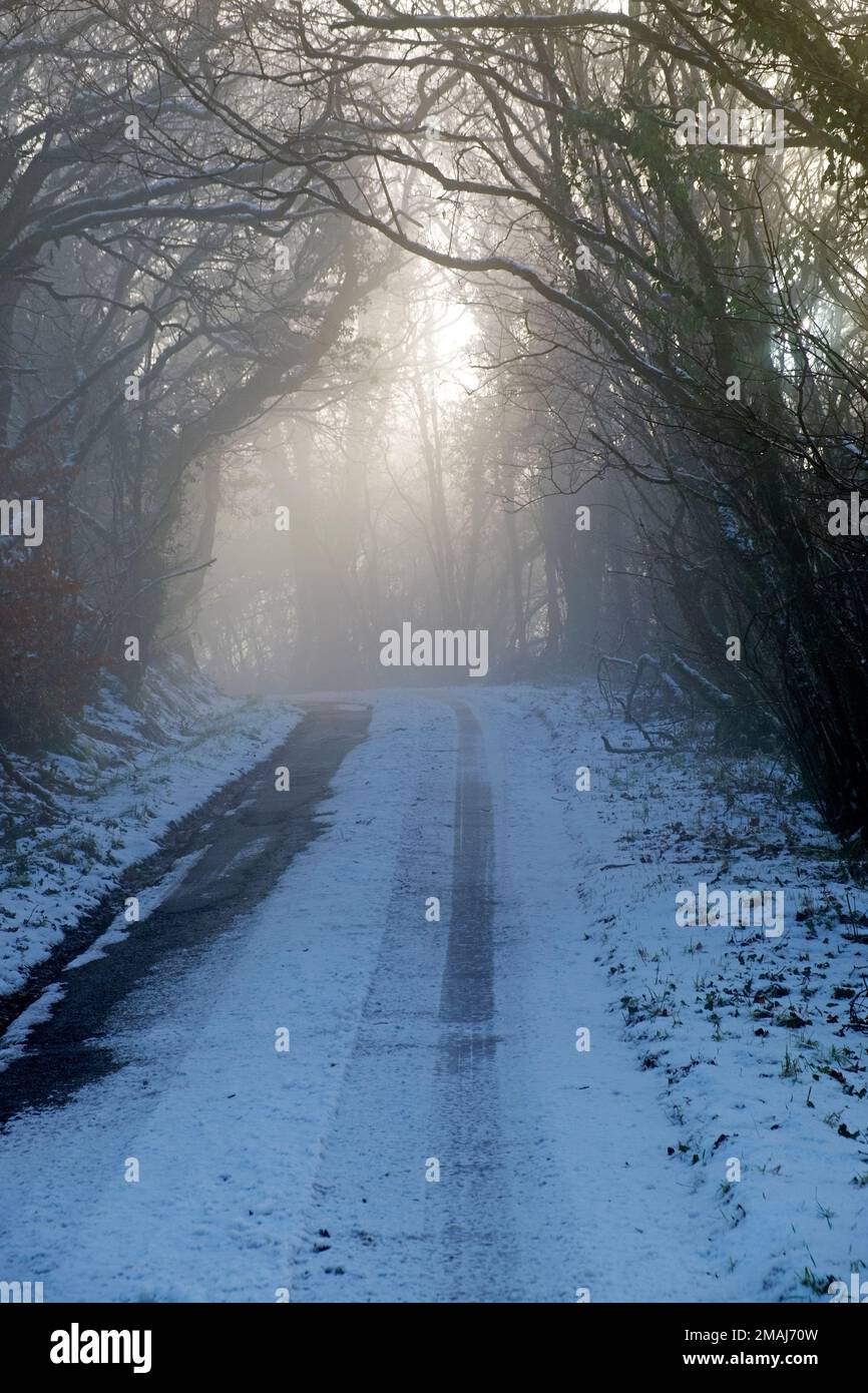 Ice freezing fog and frozen snow on rural road country lane in winter ...