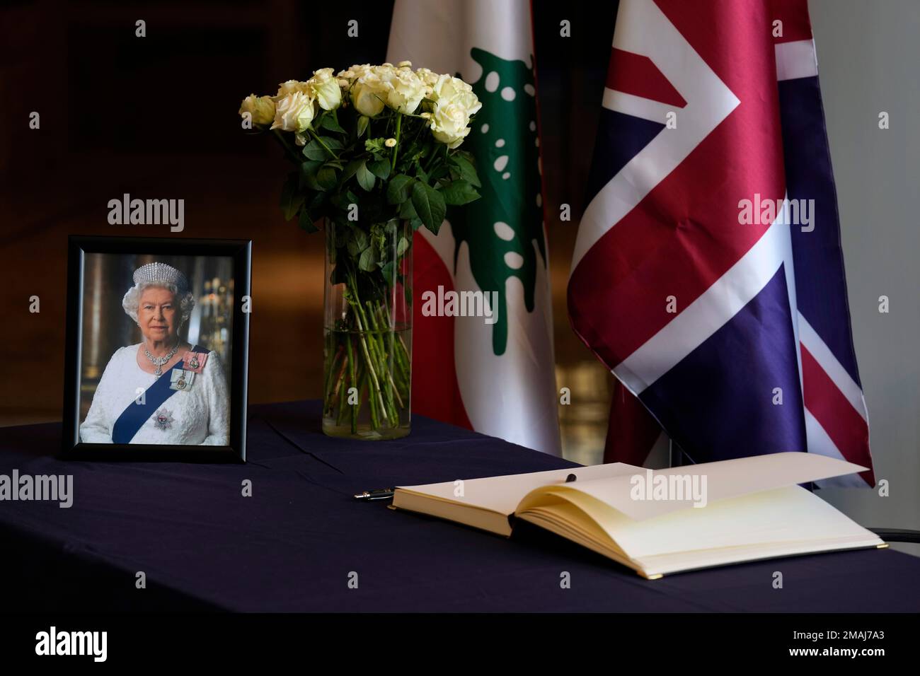A portrait of the late Queen Elizabeth II and a condolence book is on ...