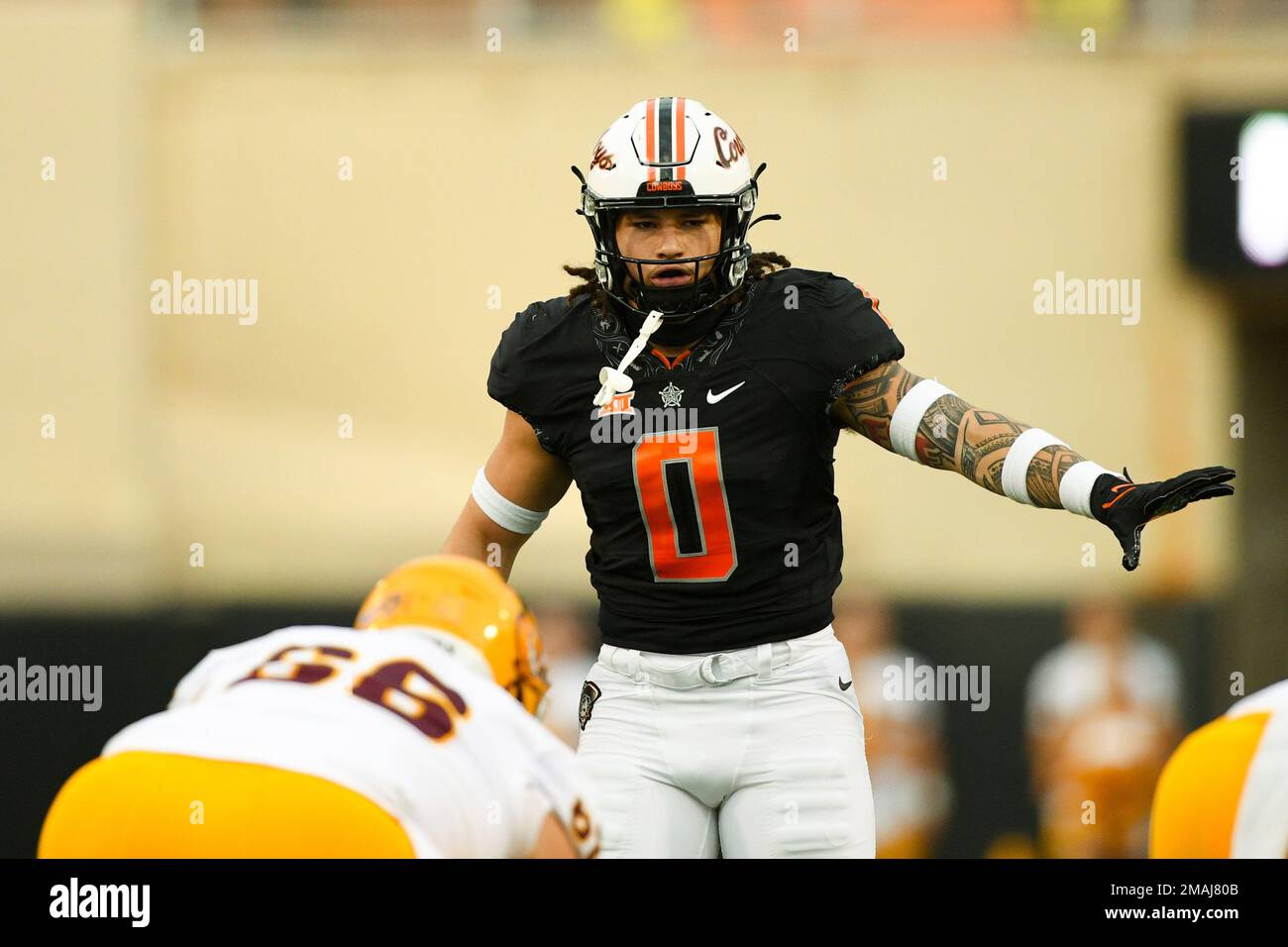Oklahoma State linebacker Mason Cobb (0) looks over to the defense ...