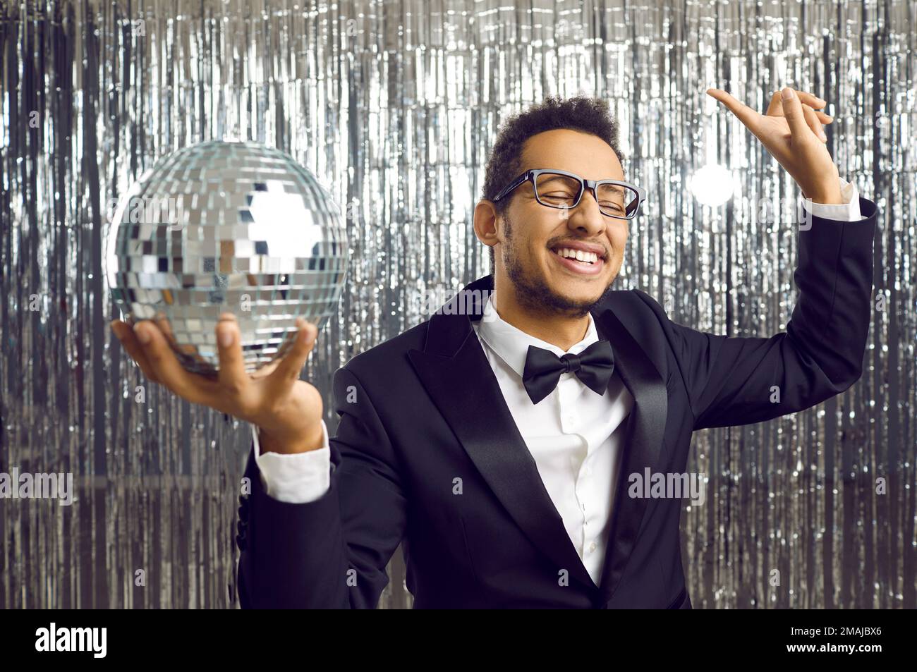 Overjoyed black man with disco ball partying Stock Photo - Alamy