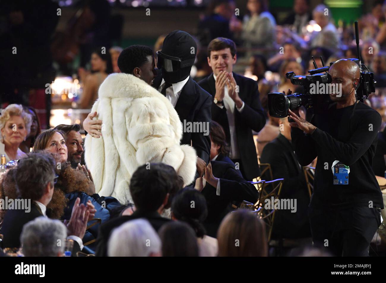 Jerrod Carmichael, left, stands after winning the Emmy for outstanding ...
