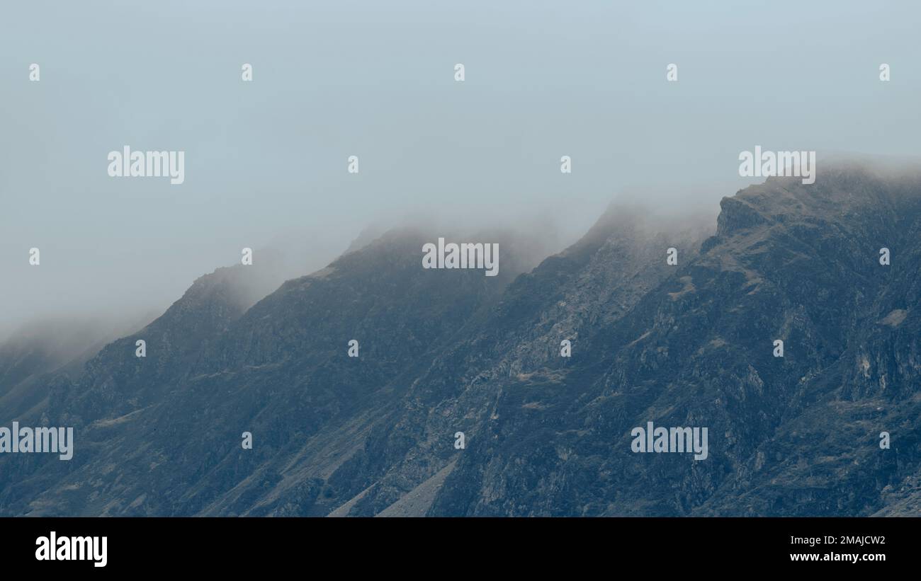 A beautiful scenery of mountain slopes covered in clouds in the ...