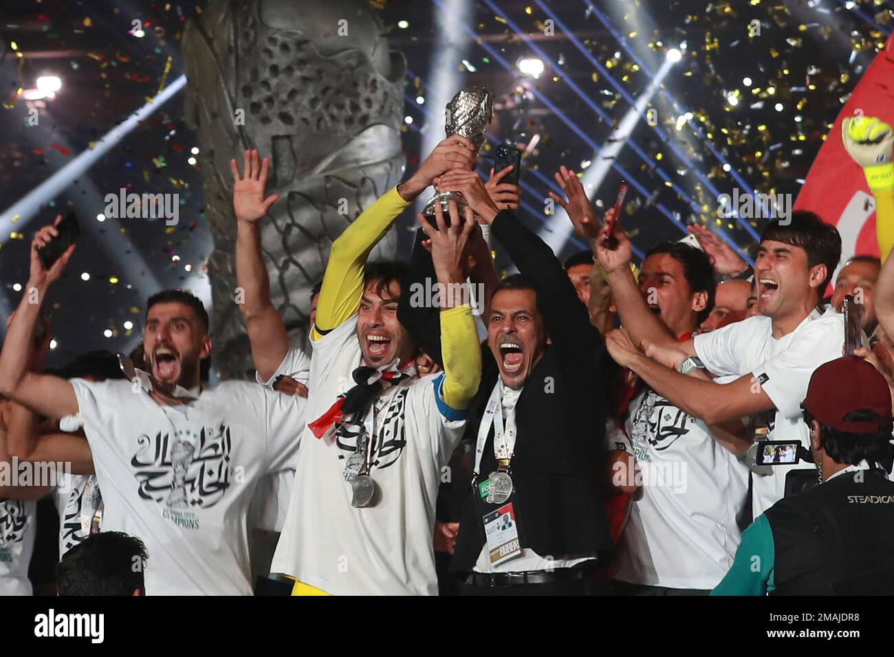 Iraq's national football team players celebrate with the trophy on the ...
