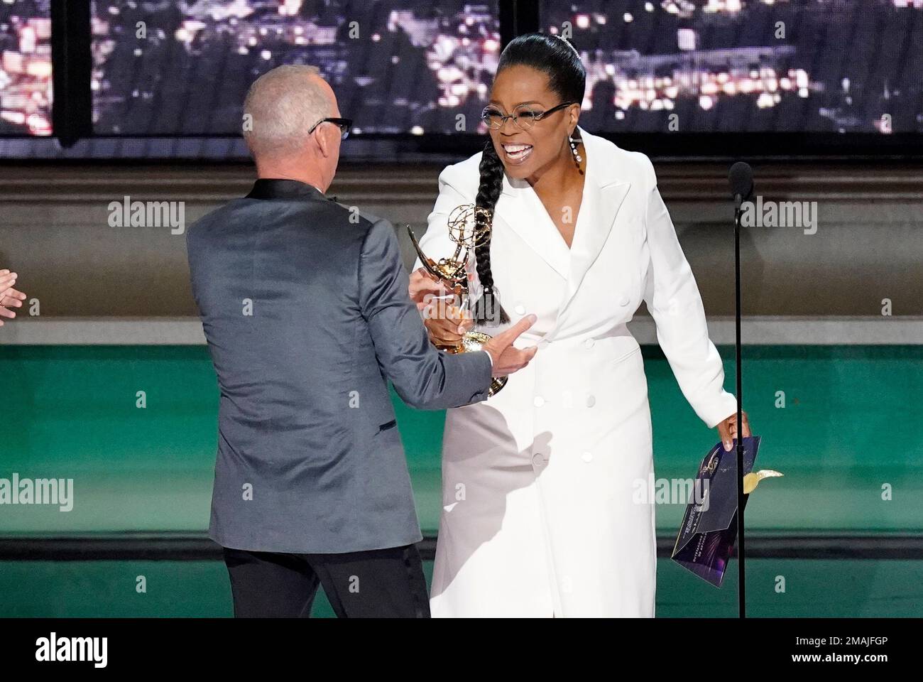 Oprah Winfrey, right, presents the Emmy for outstanding lead actor in a ...