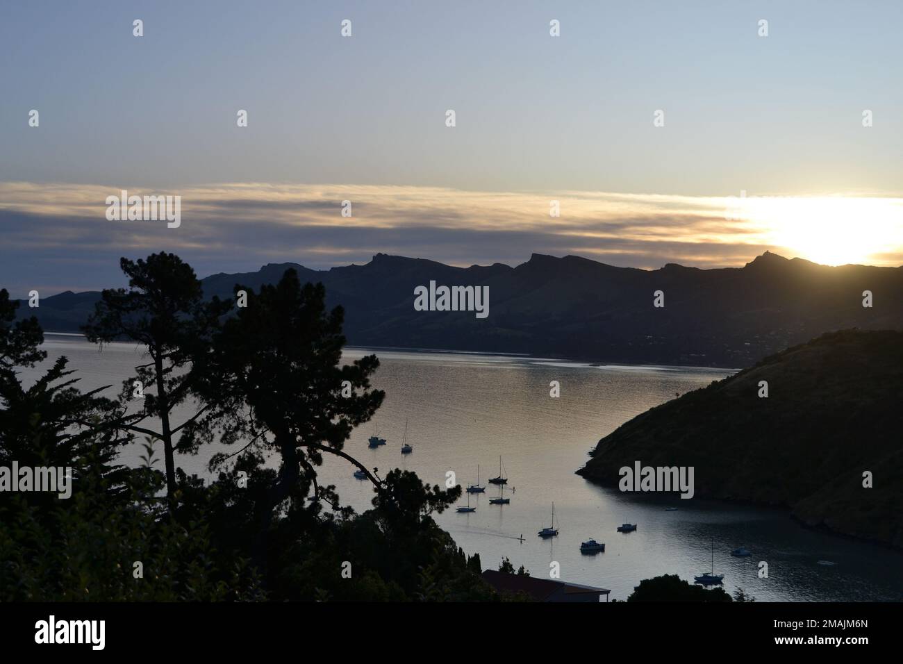 A high angle view of Cass Bay with ships and the sun shining behind ...