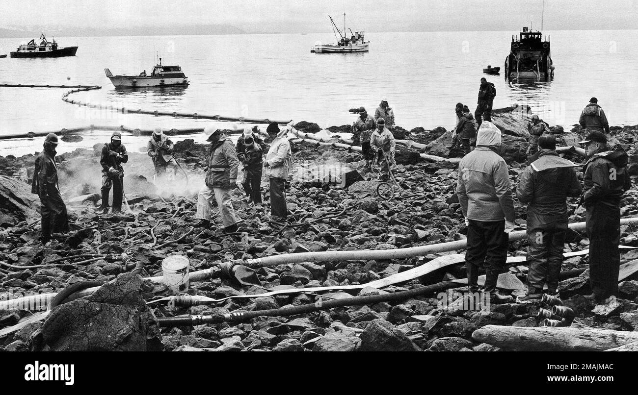 FILE - Workers test a mild chemical oil dispersant on a beach ...