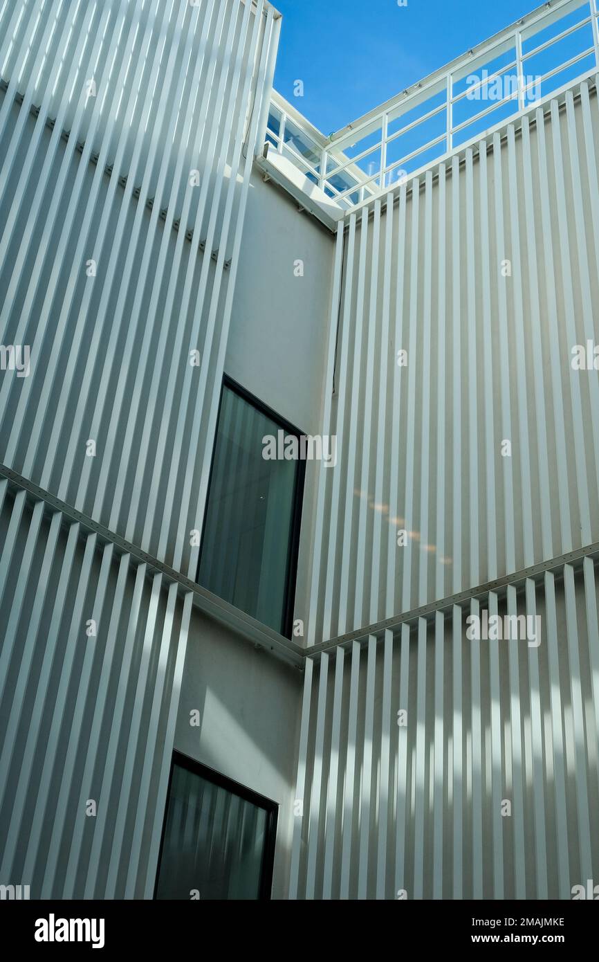 A vertical of the exterior of a modern building with vertical metal ...