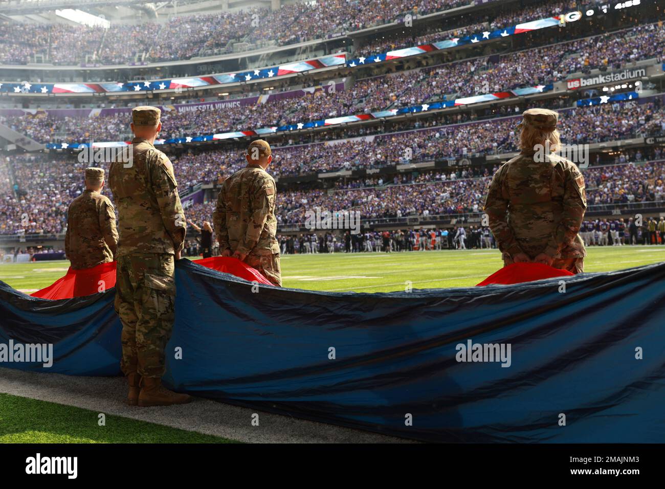Active duty servicemen and women hold the flag during the national ...