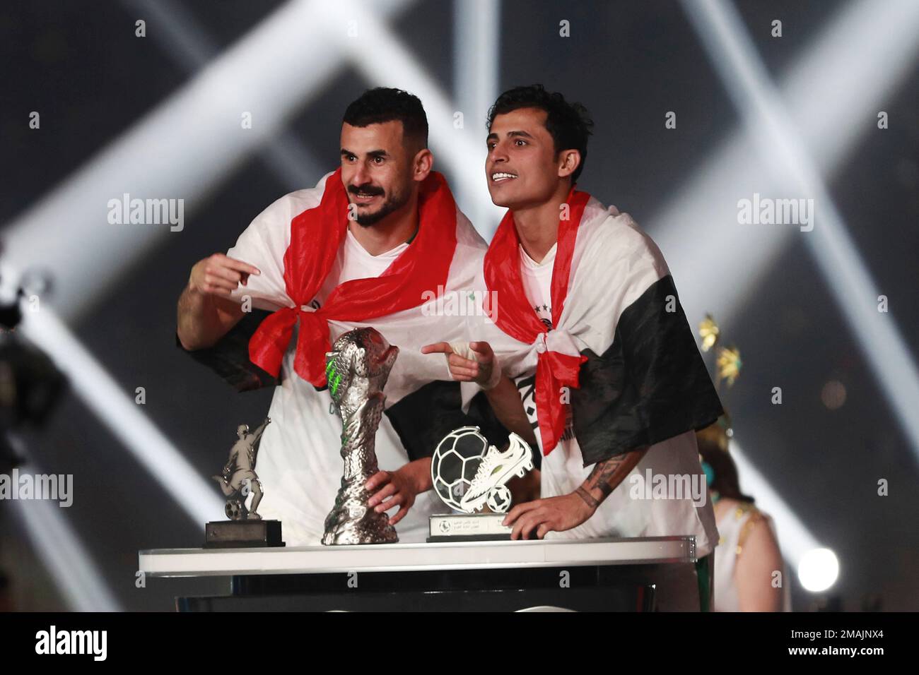 Iraq's national football team players Ayman Hussein, left, and Ibrahim Bayesh, celebrate with ...