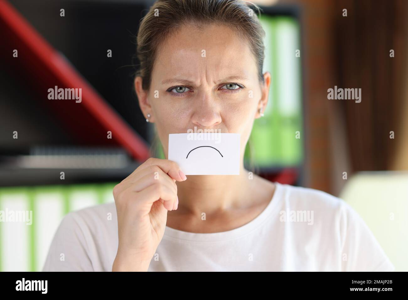 Frustrated woman covered her mouth with paper with sad emoticon Stock ...