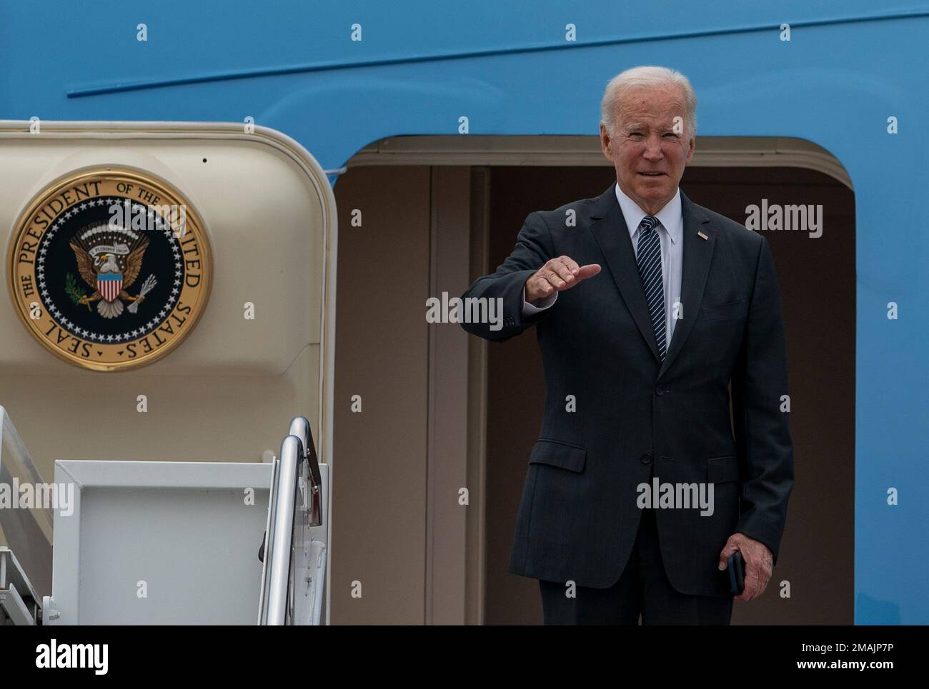 President Joe Biden returns a salute as he boards Air Force One Monday ...