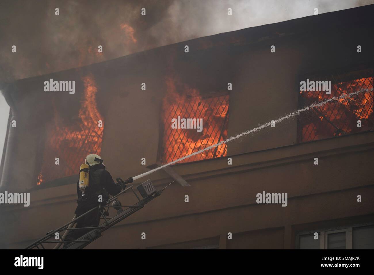 A firefighter works to extinguish a fire after a Russian attack that ...