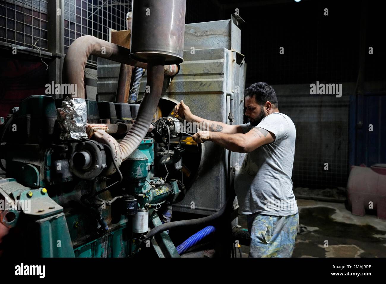 Aqeel Abdullah prepares an electricity generator to power private homes ...