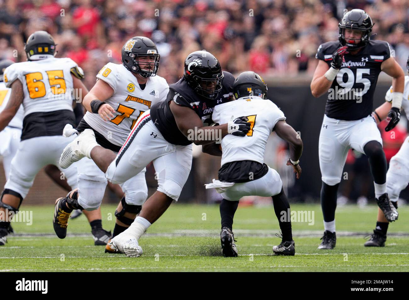 Cincinnati defensive lineman Dontay Corleone, center left, completes a ...