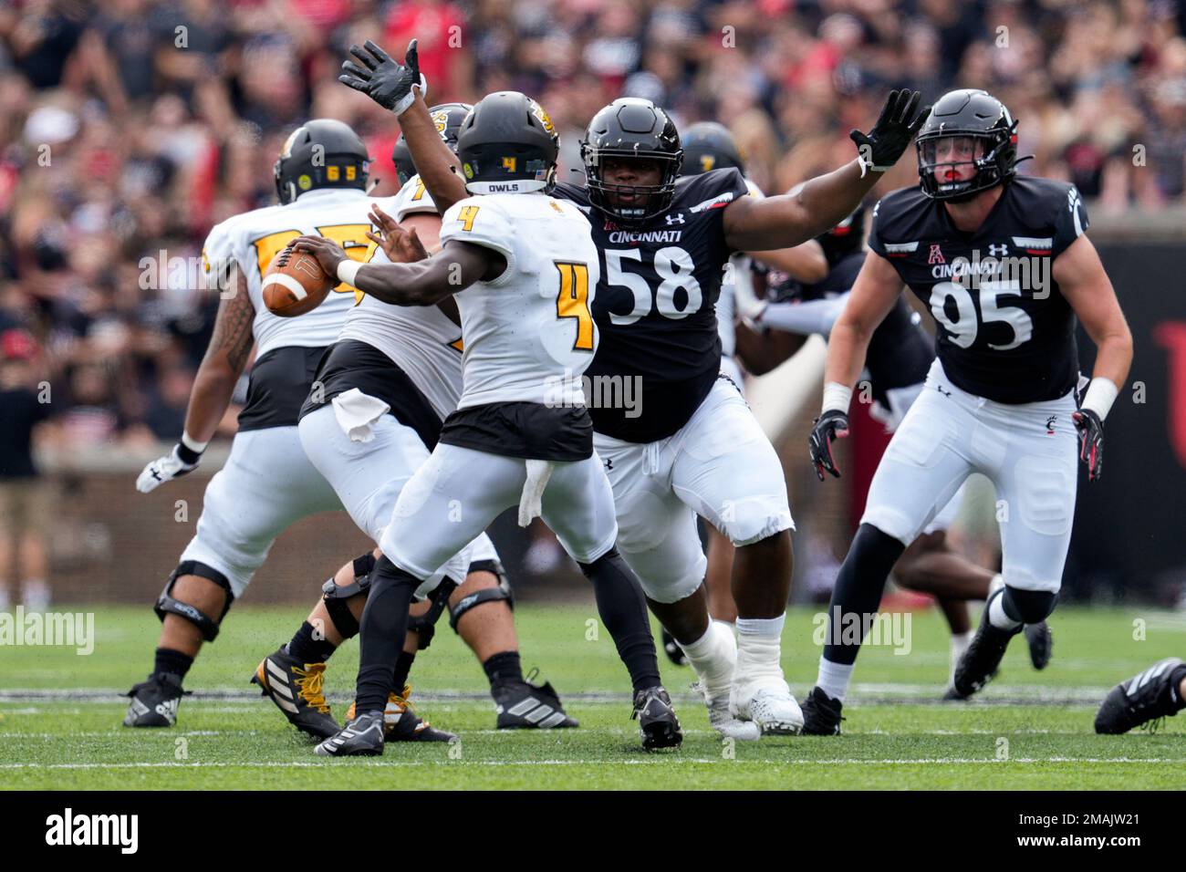 Cincinnati defensive lineman Dontay Corleone (58) completes a sack of ...
