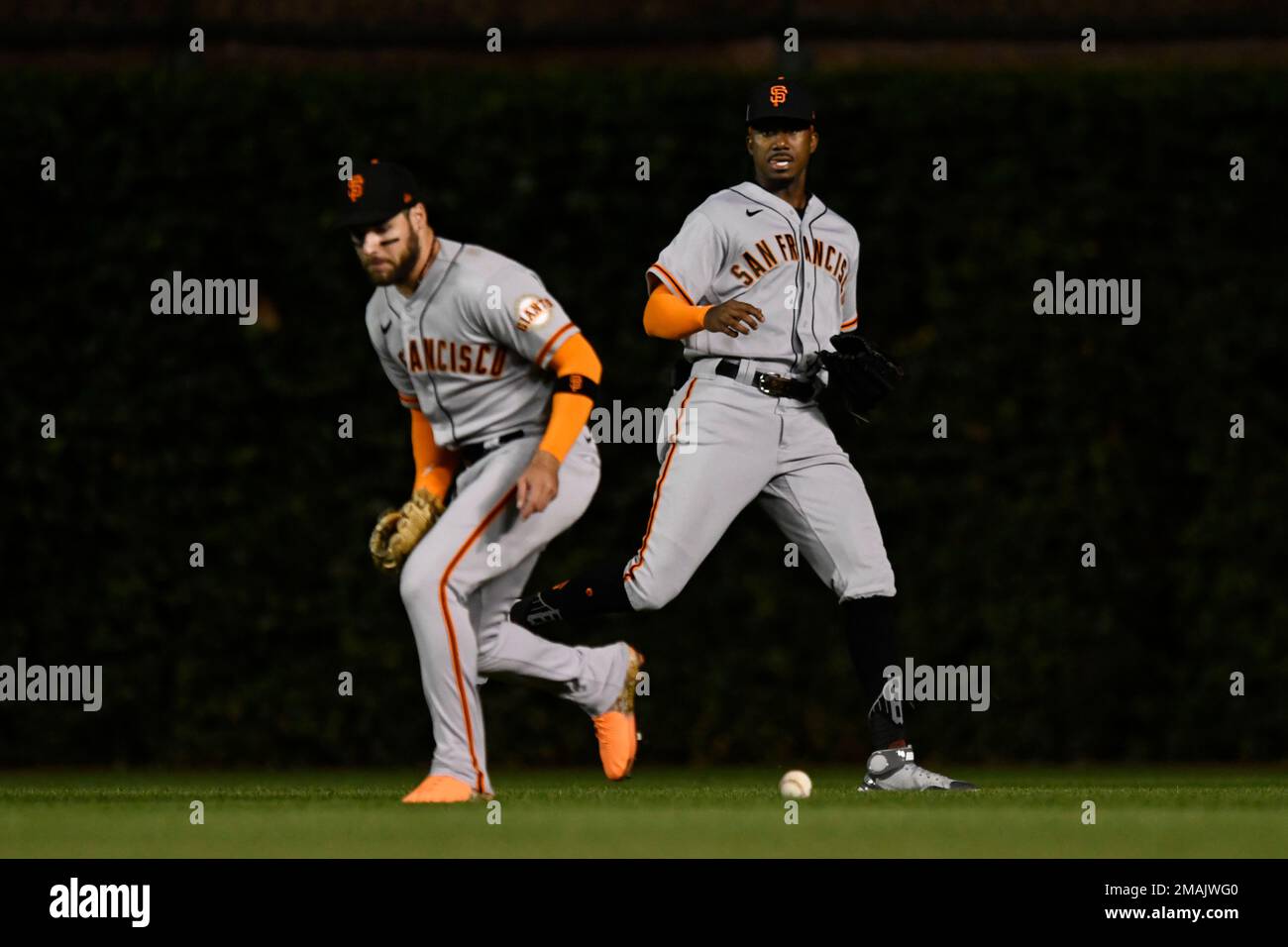 San Francisco Giants center fielder Lewis Brinson watches right fielder ...