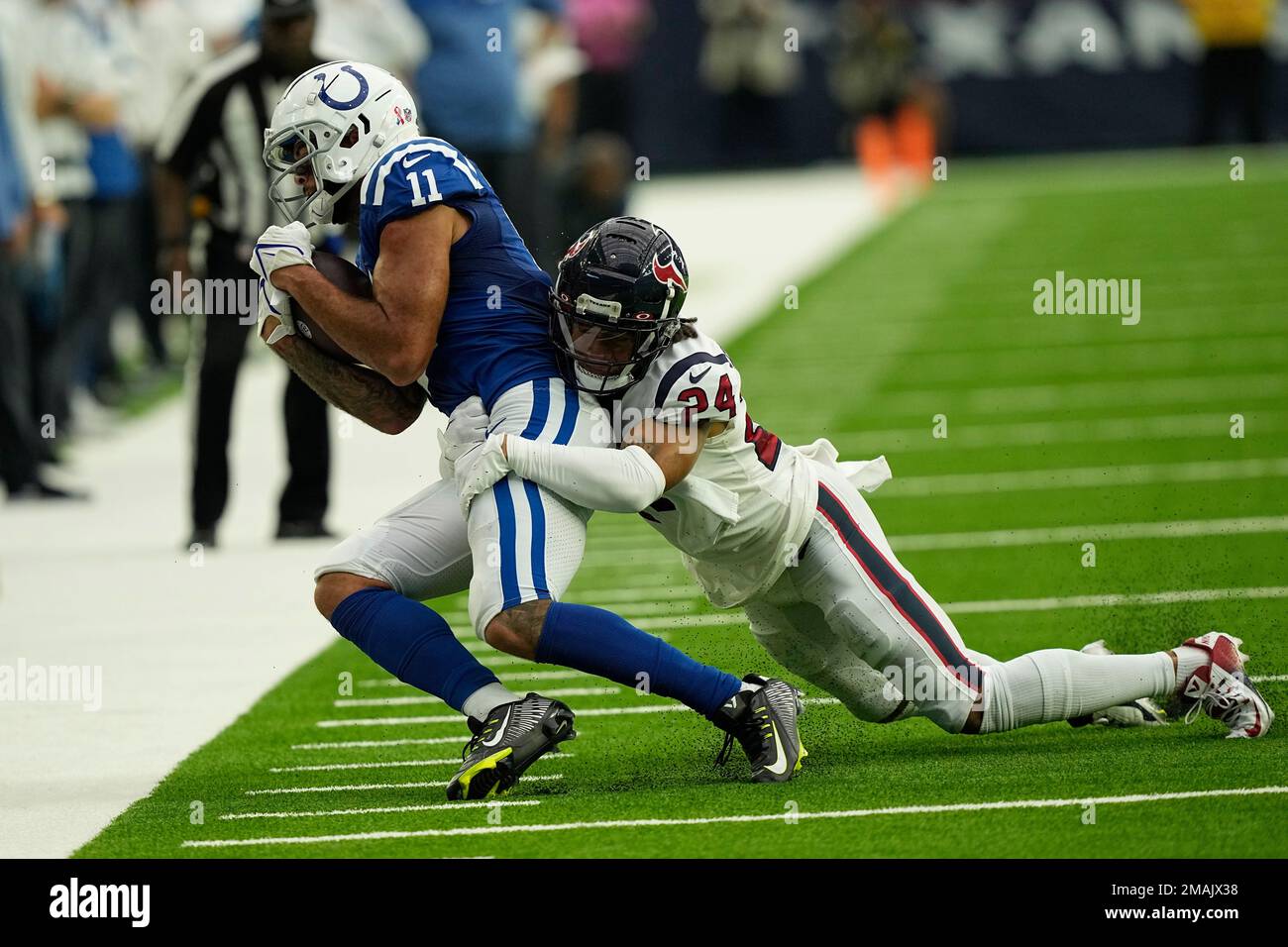 Houston Texans cornerback Derek Stingley Jr. (24) tackles Indianapolis Colts wide receiver ...