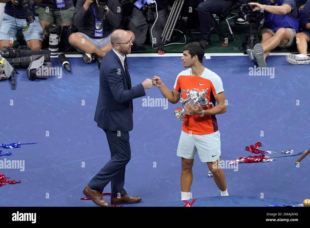 Carlos Alcaraz, of Spain, fist bumps while holding the championship ...