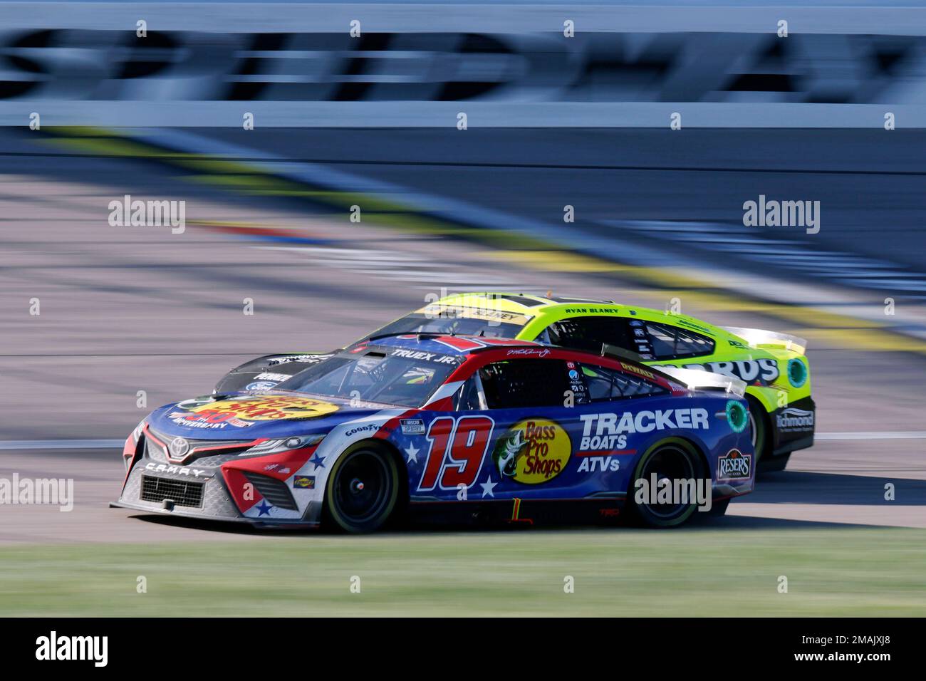 Martin Truex Jr. (19) and Ryan Blaney head down the front straightaway ...