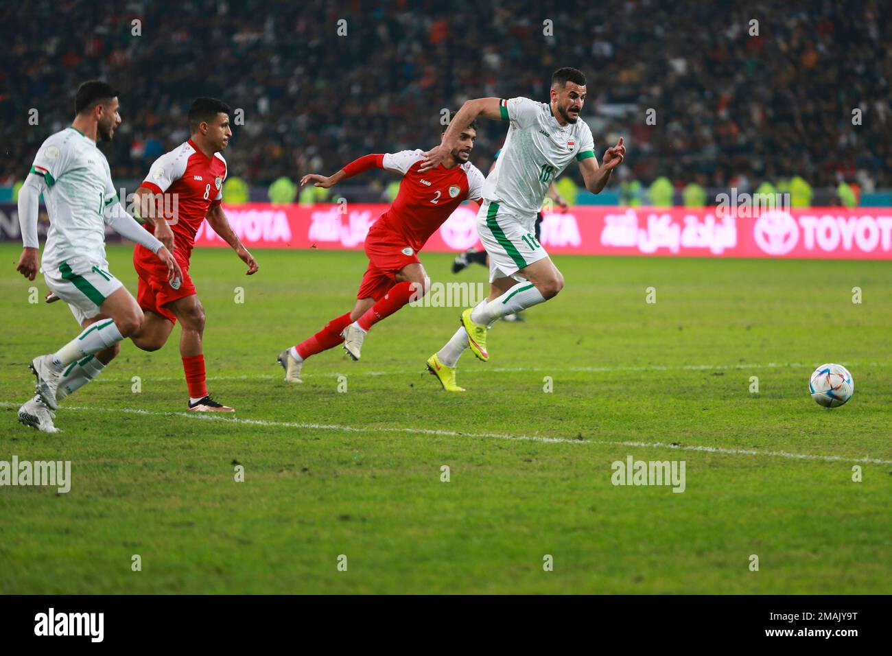 Iraq's Ayman Hussein, right, battles for the ball with Oman's Mohammed ...