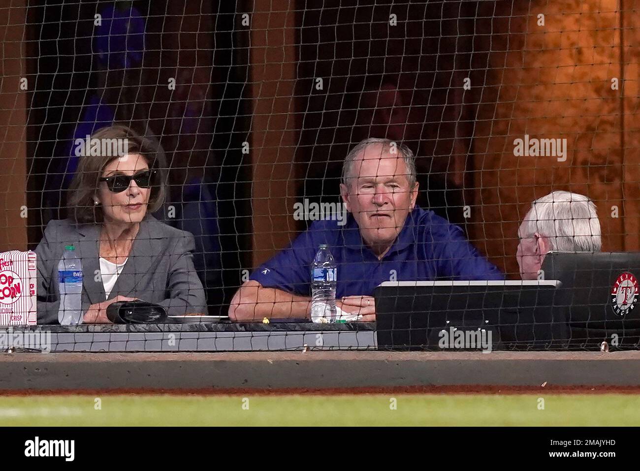 Former President George W. Bush, right, sits with his wife Laura Bush ...