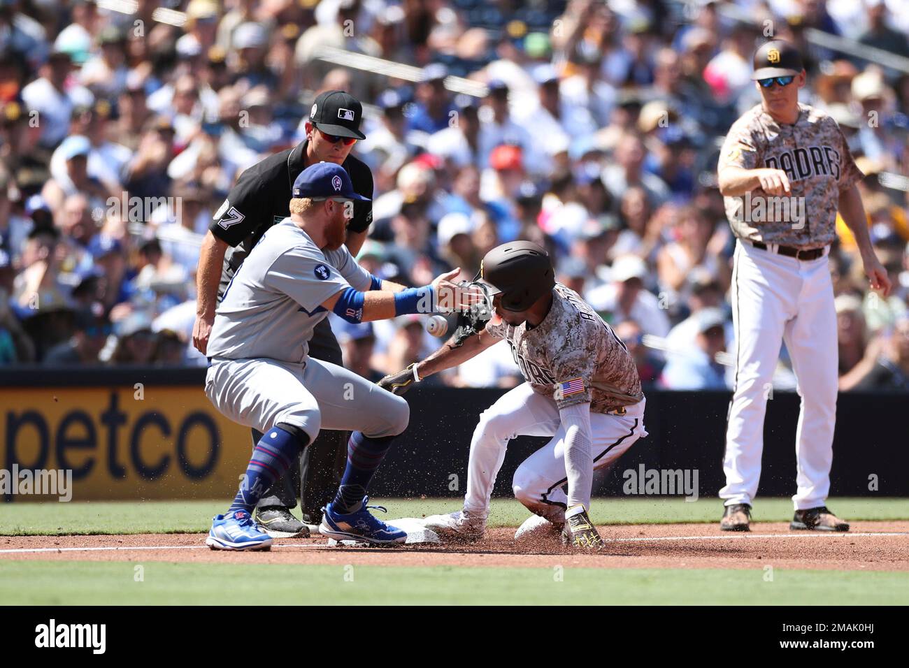 San Diego Padres' Jose Azocar, foreground right, slides safely into ...
