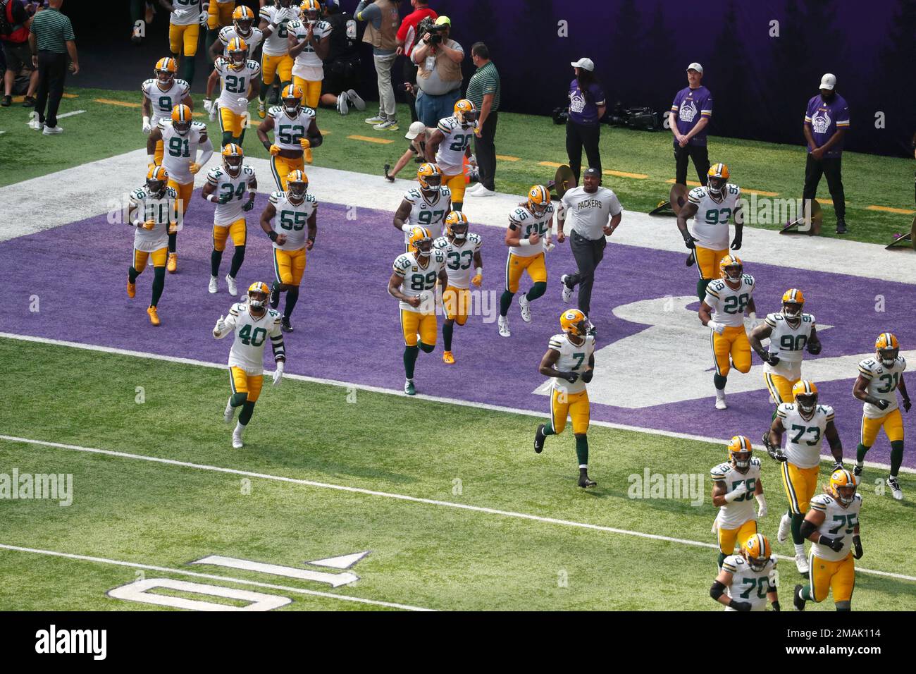 Green Bay Packers players run onto the field before an NFL football ...