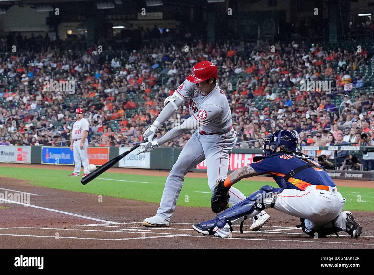 Los Angeles Angels designated hitter Shohei Ohtani, left, hits a two ...