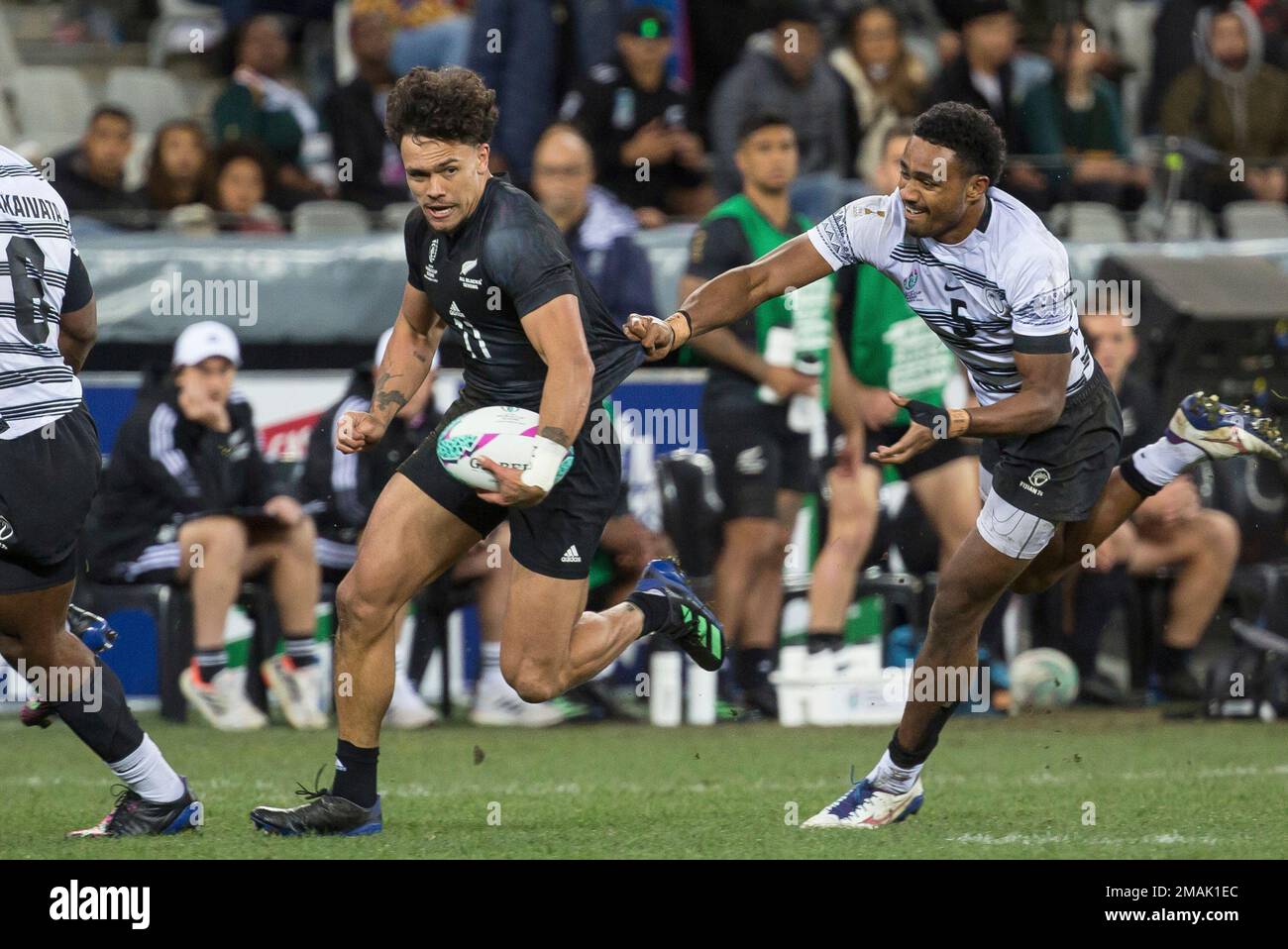 Moses Leo, left, of New Zealand is caught by Iosefo Masi of Fiji during ...