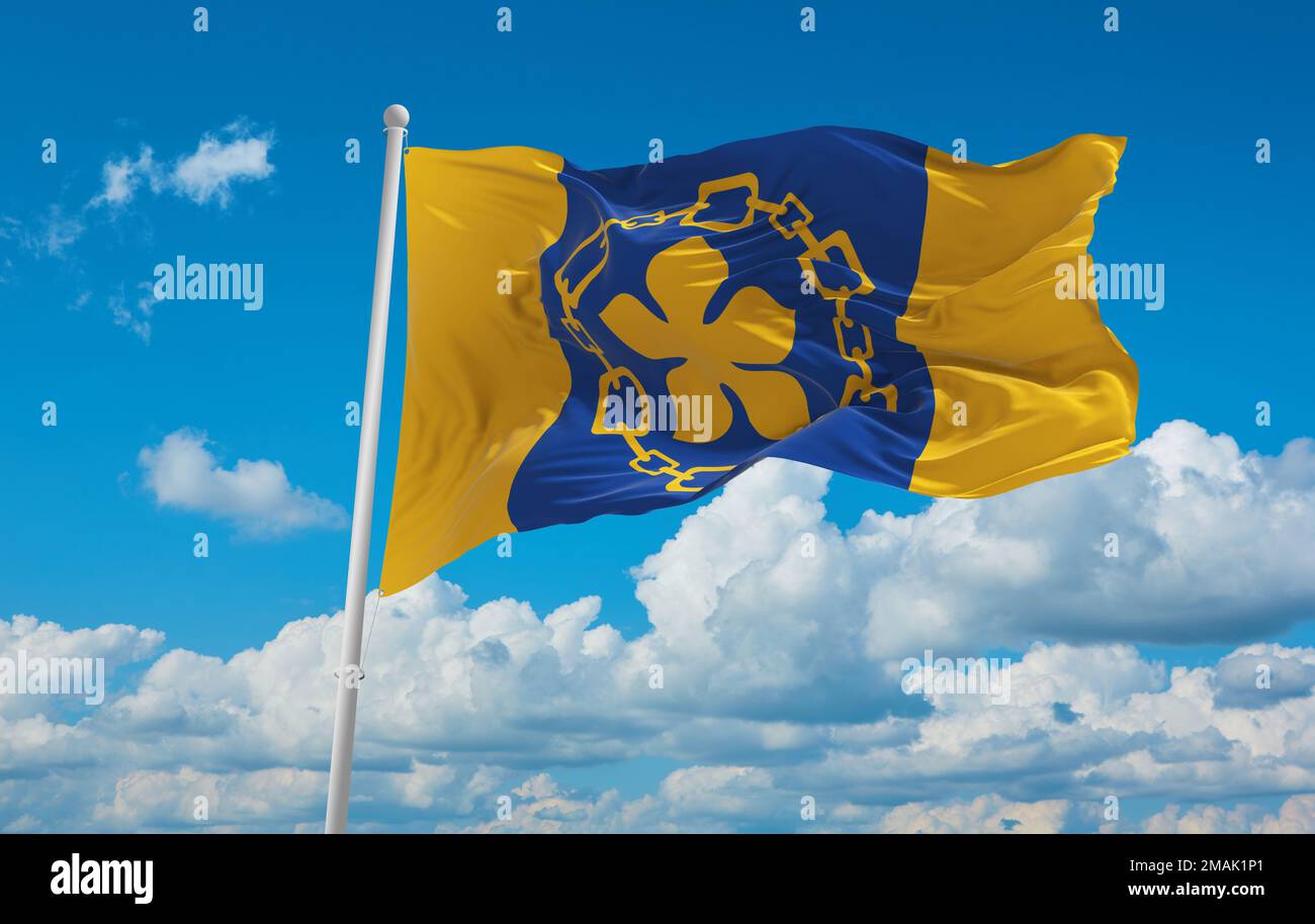 official flag of Hamilton Canada at cloudy sky background on sunset ...