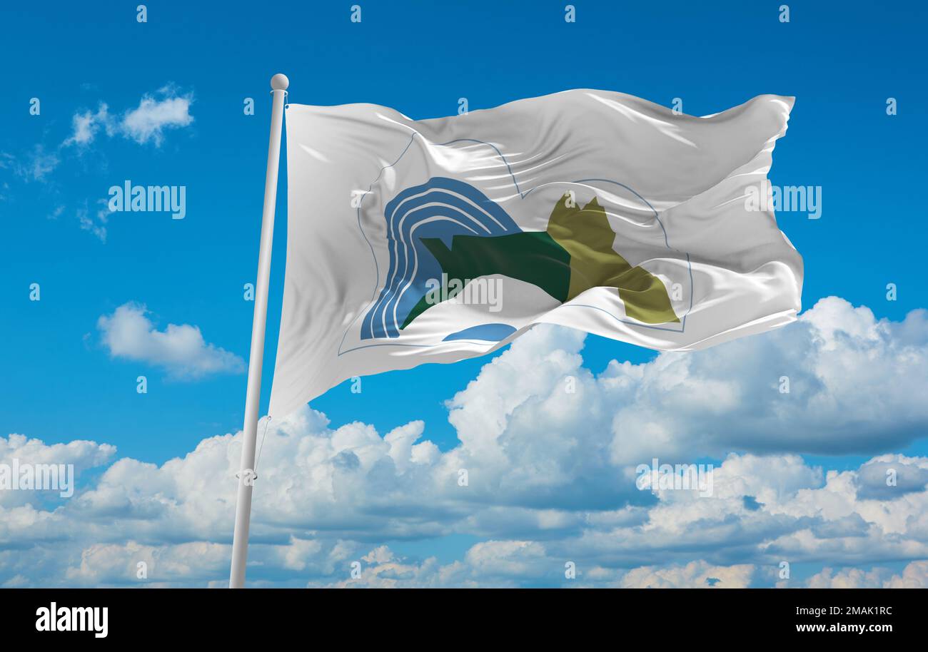 official flag of Inuvik Canada at cloudy sky background on sunset ...