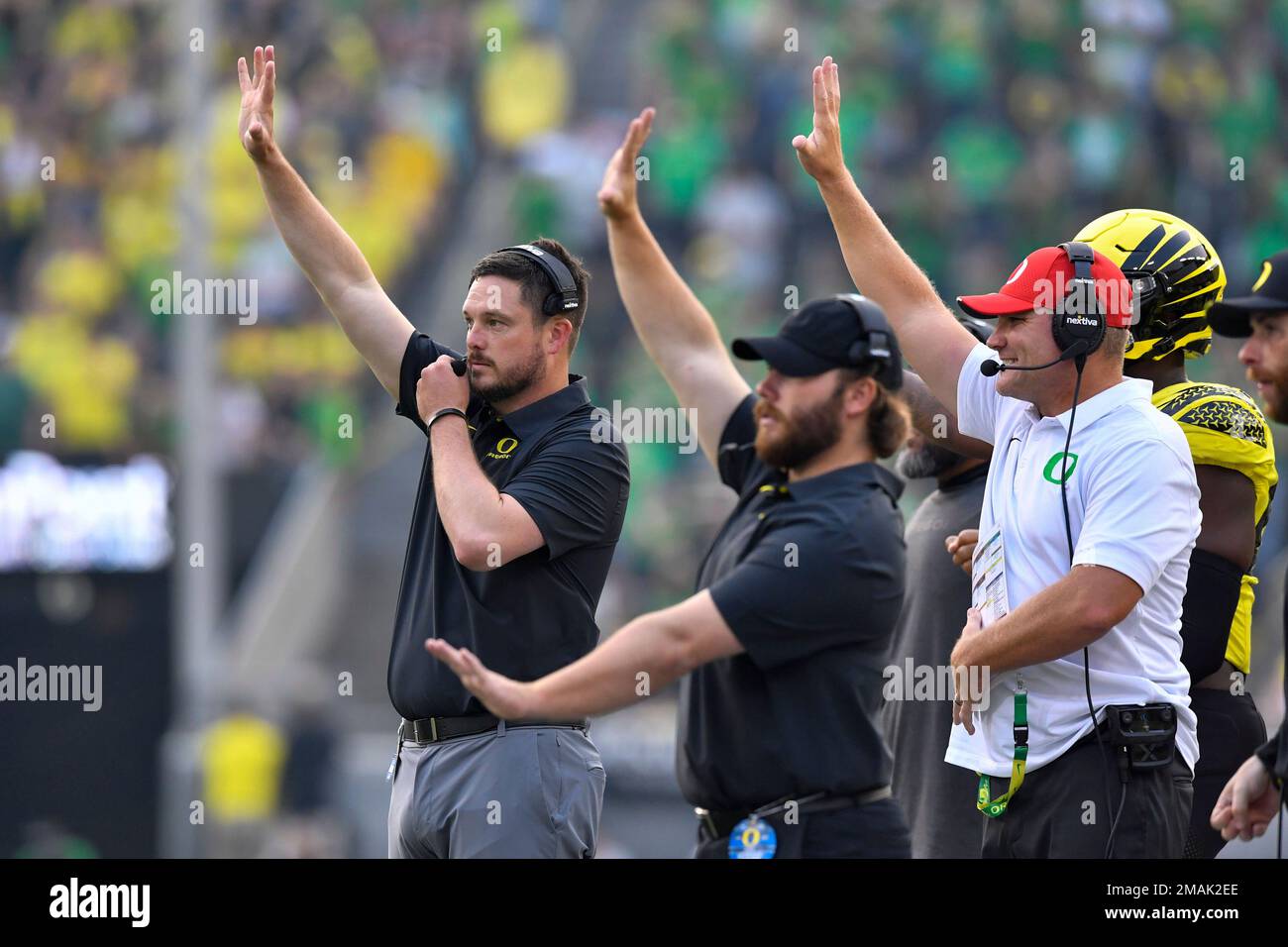 Oregon head coach Dan Lanning, left, communicates with his defense ...