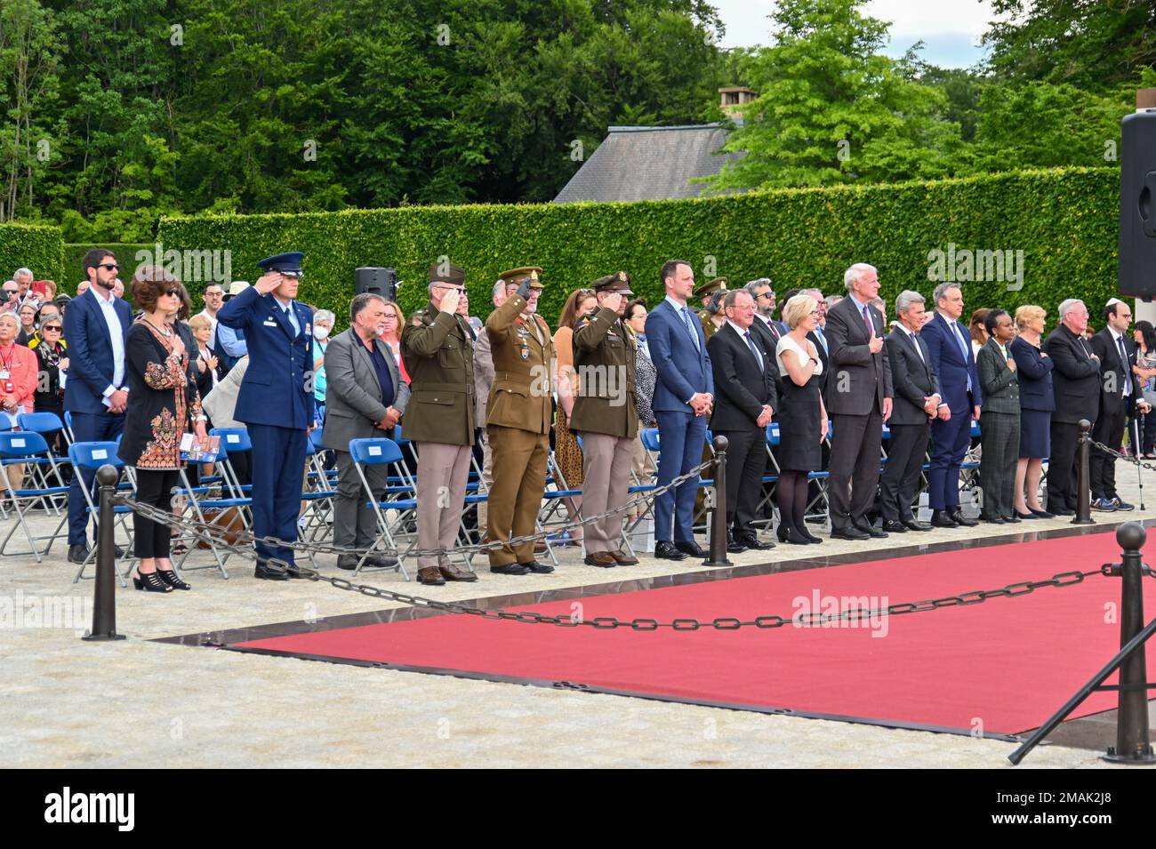 The official party stands and salutes during a Memorial Day event at ...
