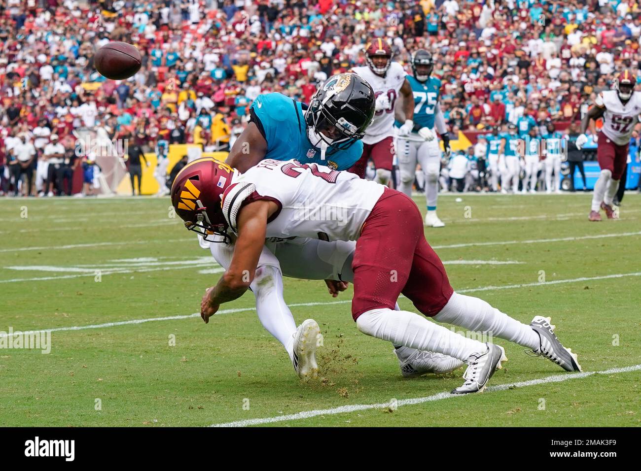 Washington Commanders safety Darrick Forrest (22) knocks the ball out ...