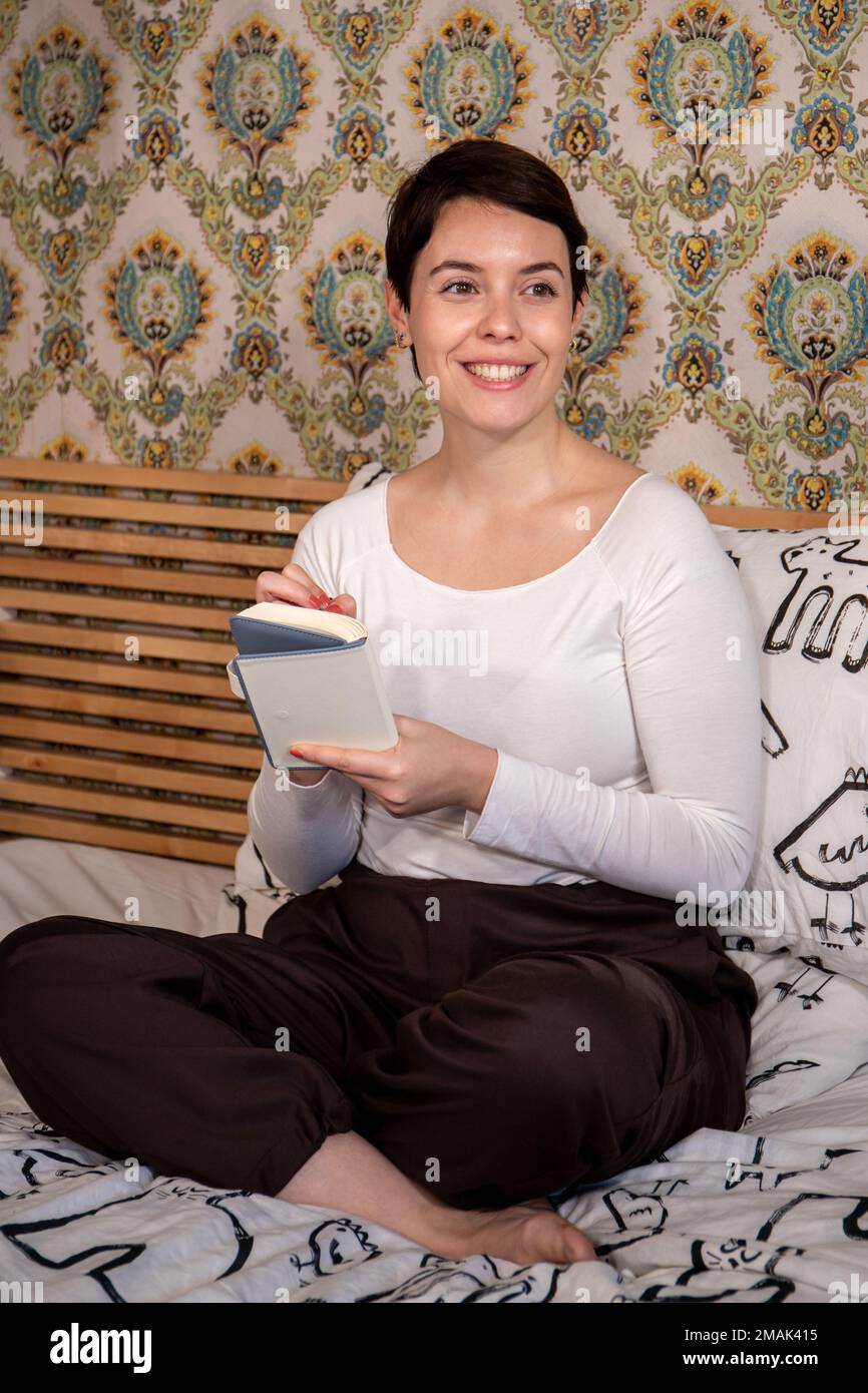 Donna is writing on her personal organizer. The beautiful woman is ...