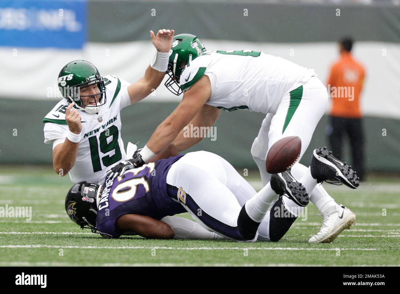 New York Jets quarterback Joe Flacco (19) is hit by Baltimore Ravens ...