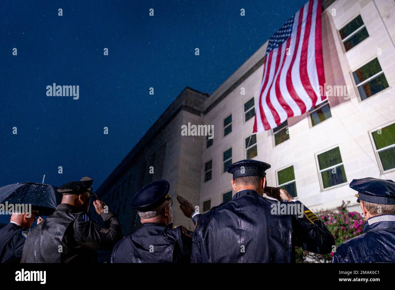 First responders salute as a U.S. flag is unfurled at the Pentagon in ...