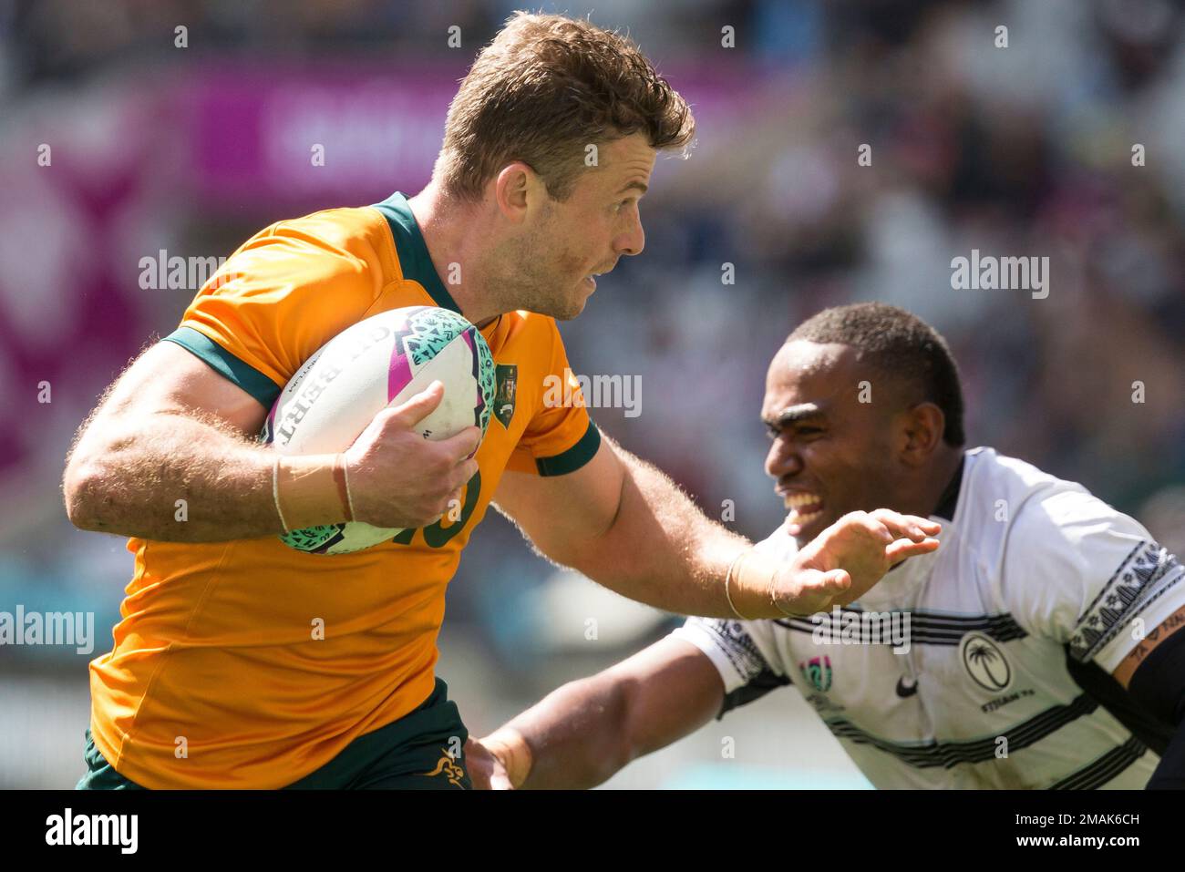 Maurice Longbottom of Australia, left, on his way to the try line ...