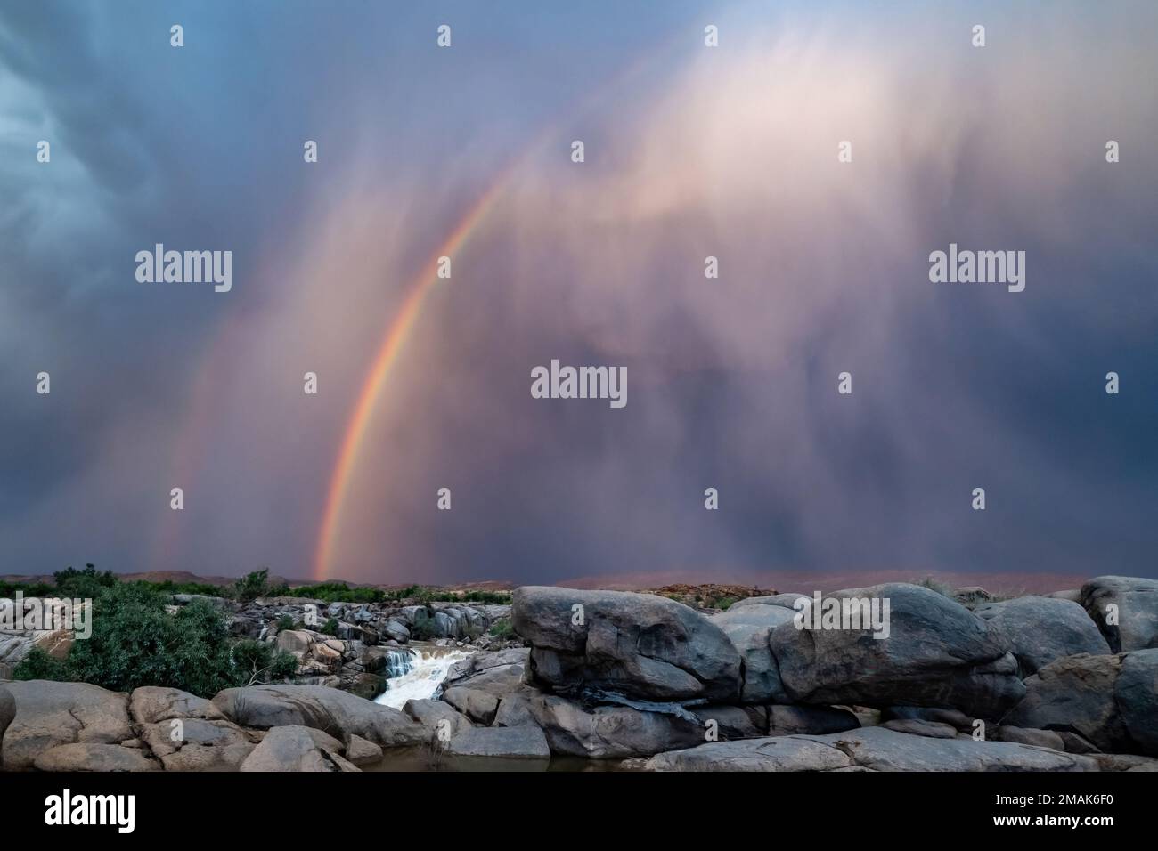 Rainbow and storm clouds. Augrabies Falls National Park. Northern Cape ...