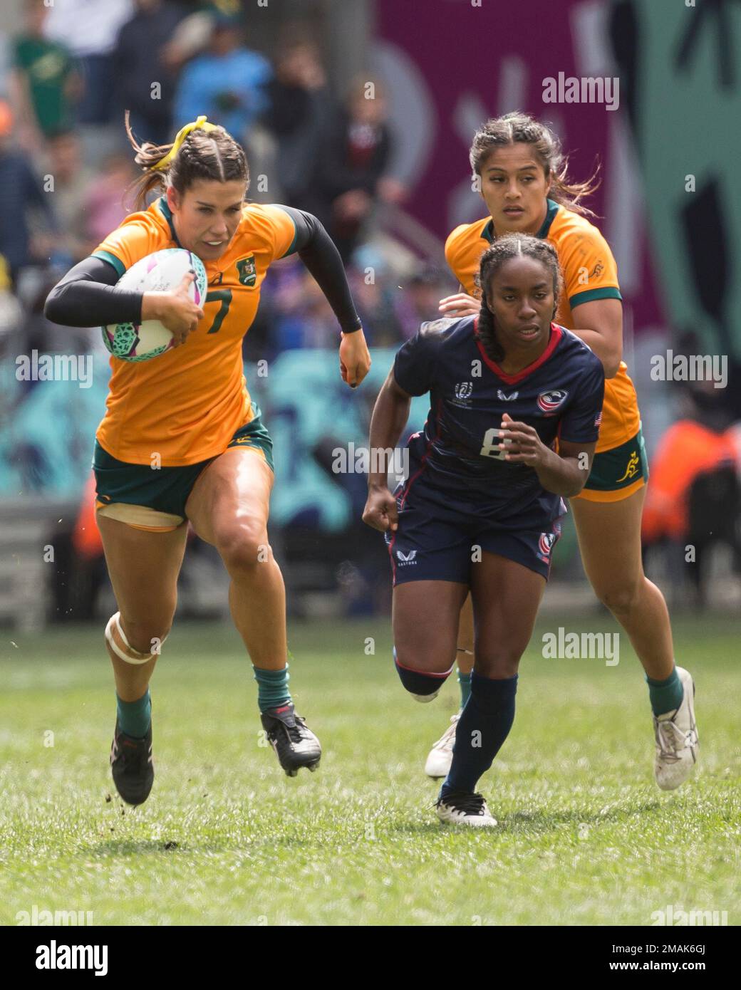 Charlotte Caslick of Australia races away from Jaz Gray of USA in a semi final match during the ...