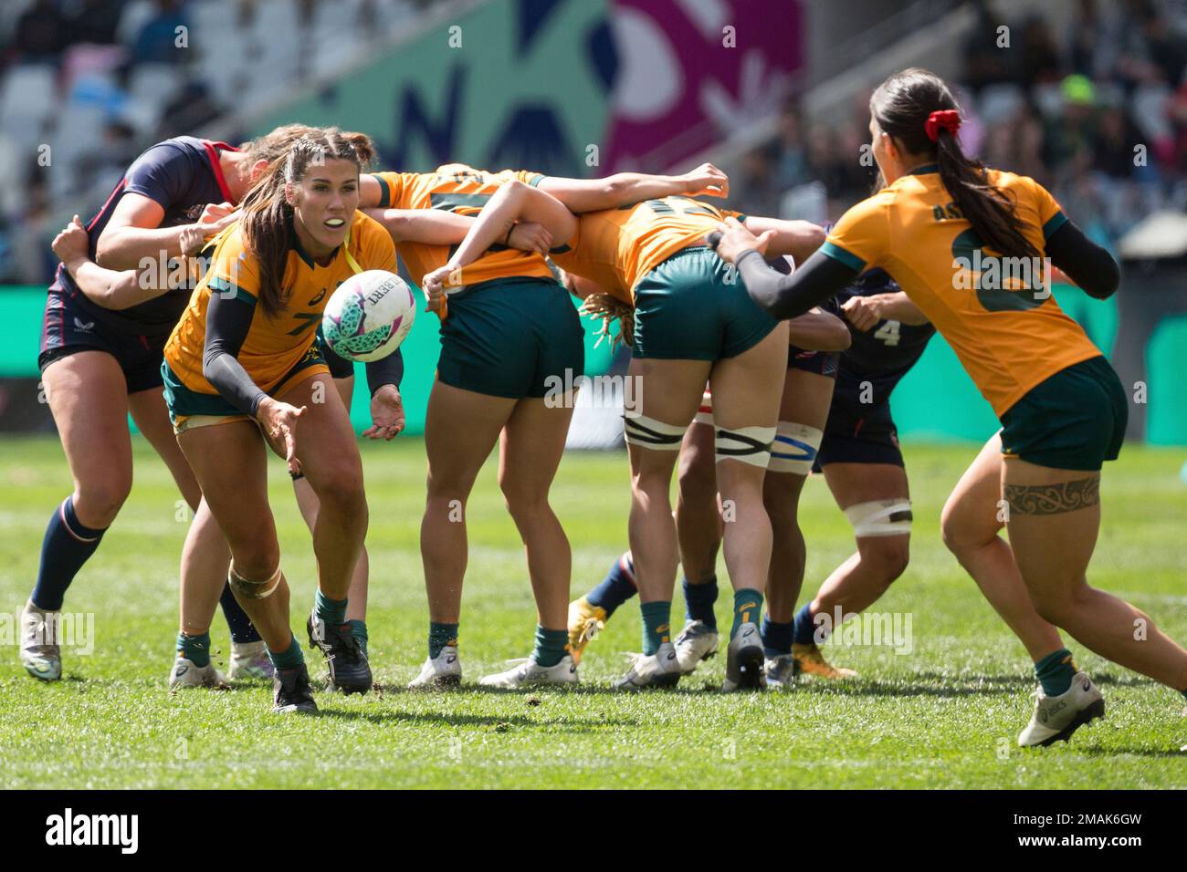 Charlotte Caslick of Australia passes the ball from a scrum to teammate ...