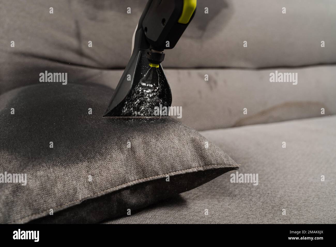 Dry cleaning extractor machine is spraying water and detergent close-up ...