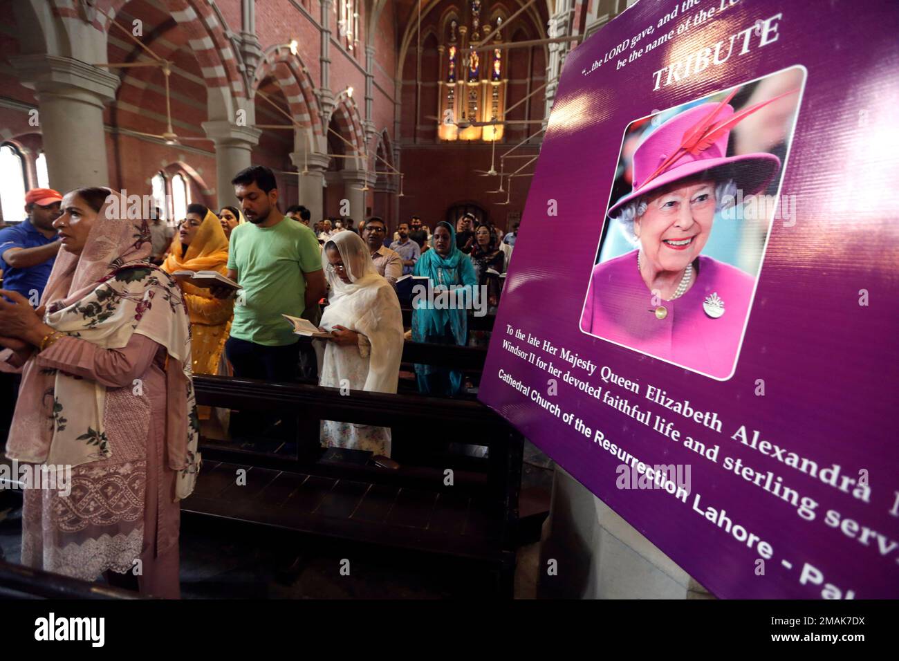 A portrait of the late Queen Elizabeth II is on display as people pay ...