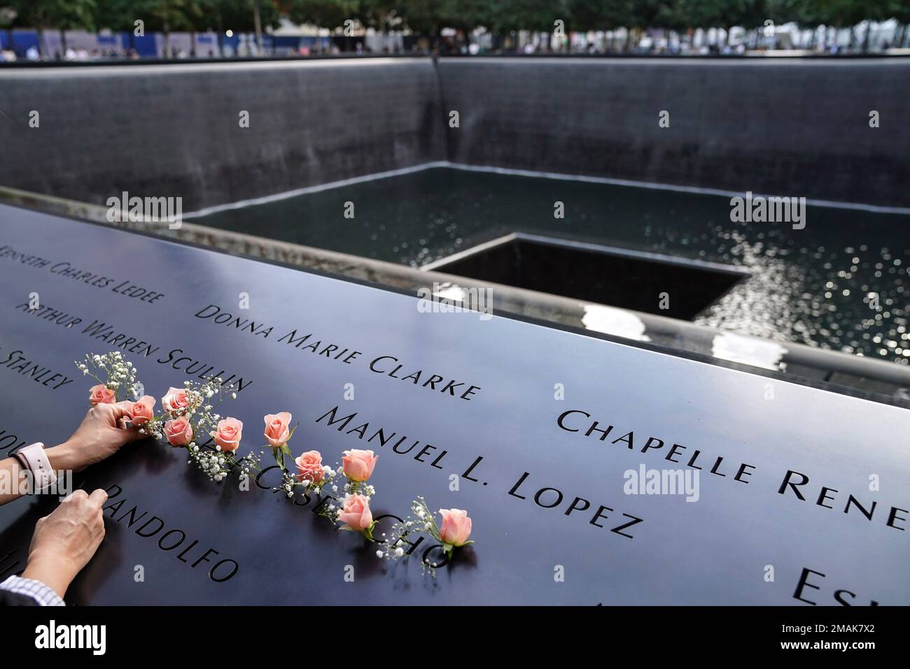 FILE - Mourners place flowers in the name cut-out of Kyung Hee (Casey ...