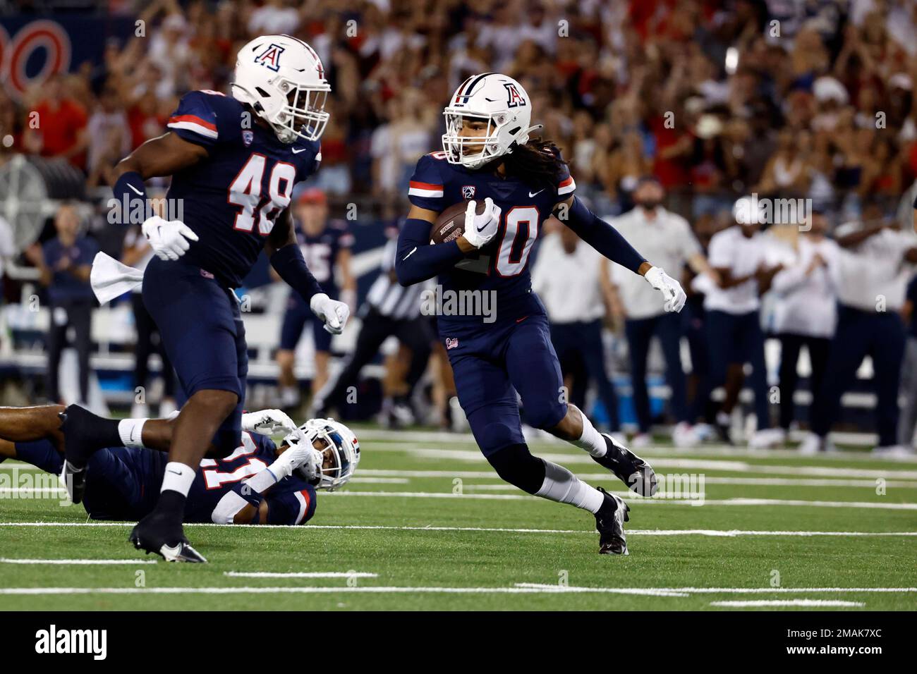 Arizona cornerback Treydan Stukes (20) returns an interception in the ...